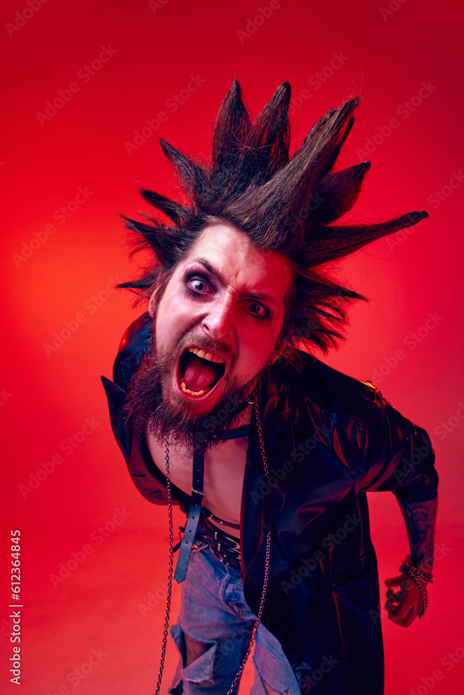 Crazy face. Portrait of expressive young man, punk posing in makeup and ...