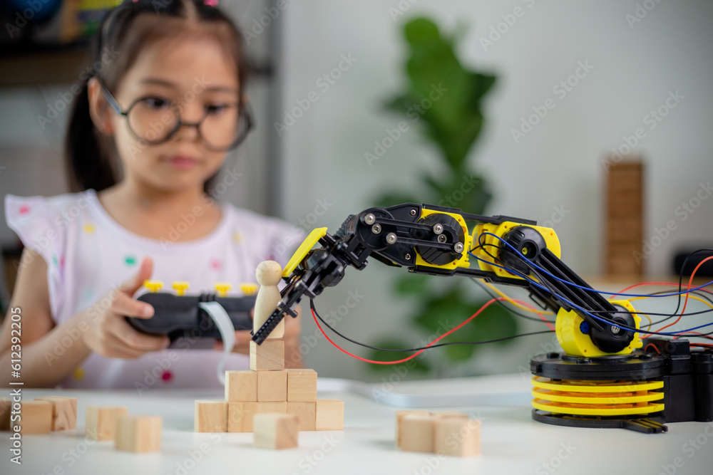 STEM education concept. Asian students learn at home by coding robot arms in STEM, mathematics ...