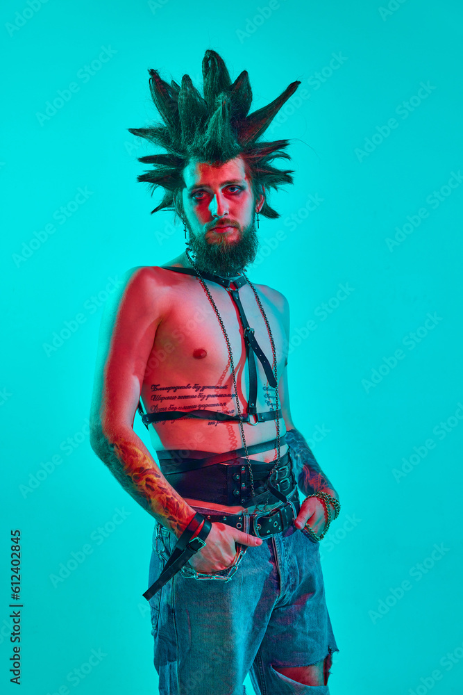 Shirtless young man, rock musician punk with crazy hairdo and makeup ...