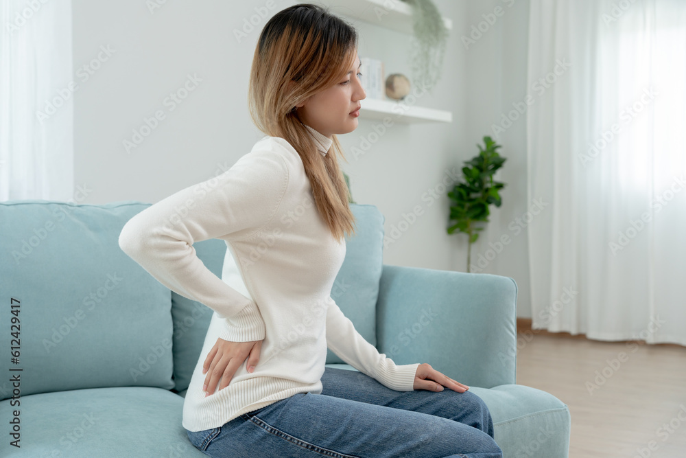 Asia beautiful woman holding her lower back while and suffer from ...
