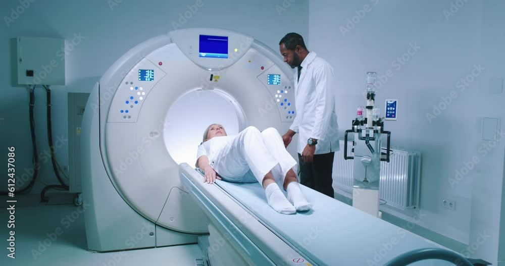 Woman lies on MRI capsule table. Examination of magnetic resonance ...