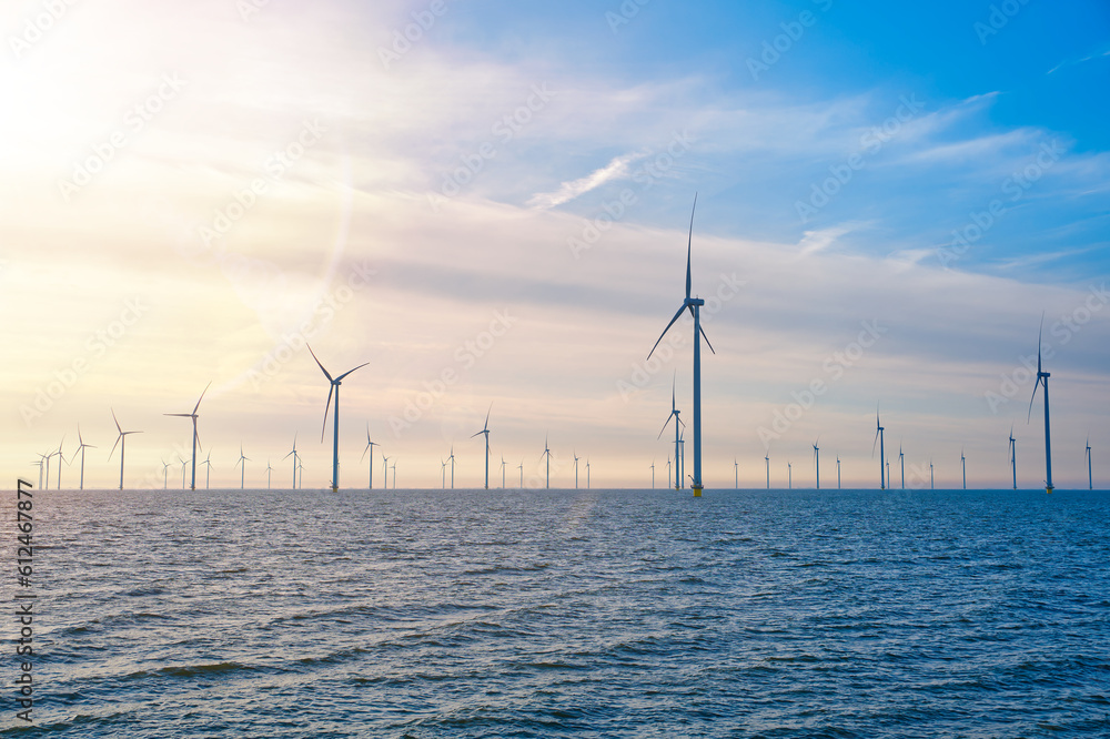 Offshore Windmill farm. windmills isolated at sea on a beautiful bright ...