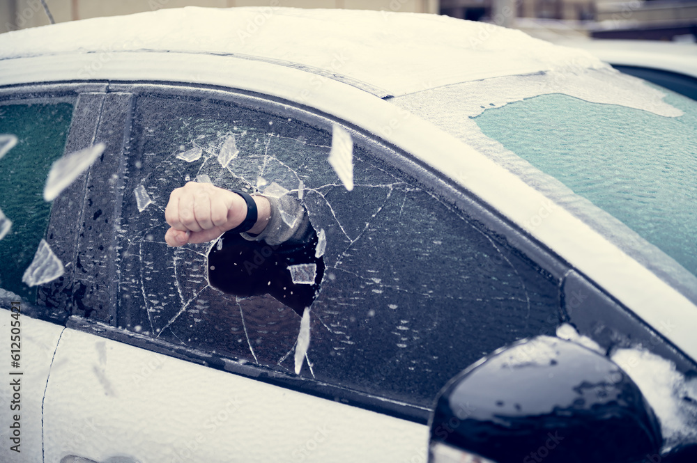 A fist from inside the car breaks the ice, instead of the side window ...