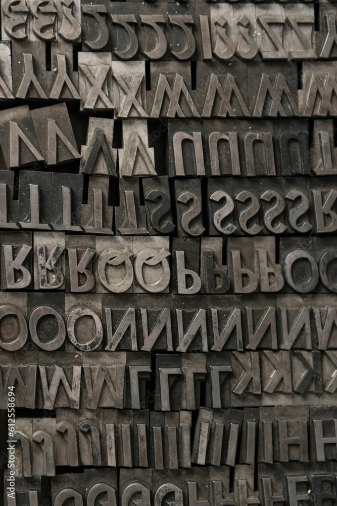 Vertical shot of metal-type letters in rows, shapes and forms of an ...