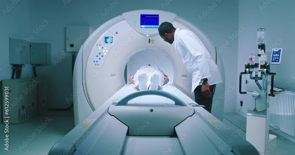 Patient is undergoing MRI procedure. Multucultural medical worker ...