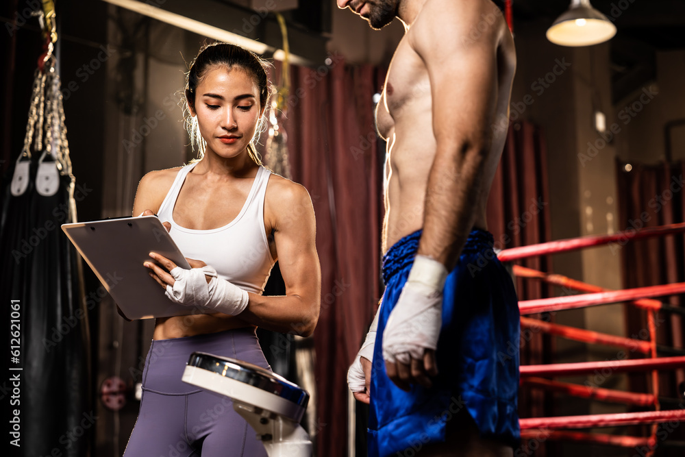 Muay Thai boxer step on weight scale for boxing class designation by ...