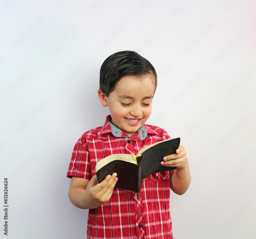 child reading the bible, open bible, smile, three-quarter view, holding ...