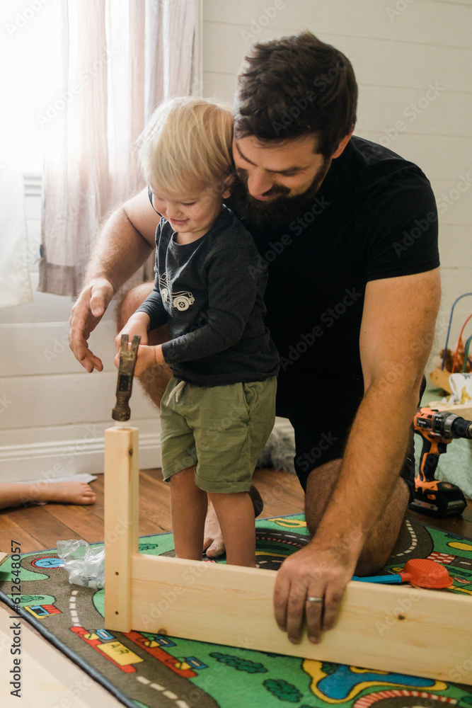 Father teaching toddler son to use a hammer Stock Photo | Adobe Stock