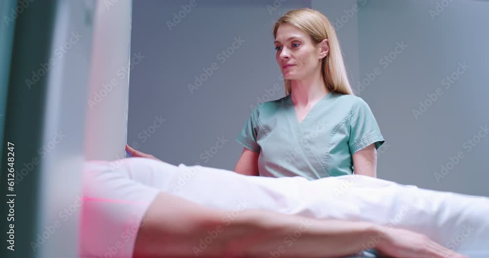 Shoot from side. Male patient is undergoing MRI tomography procedure ...