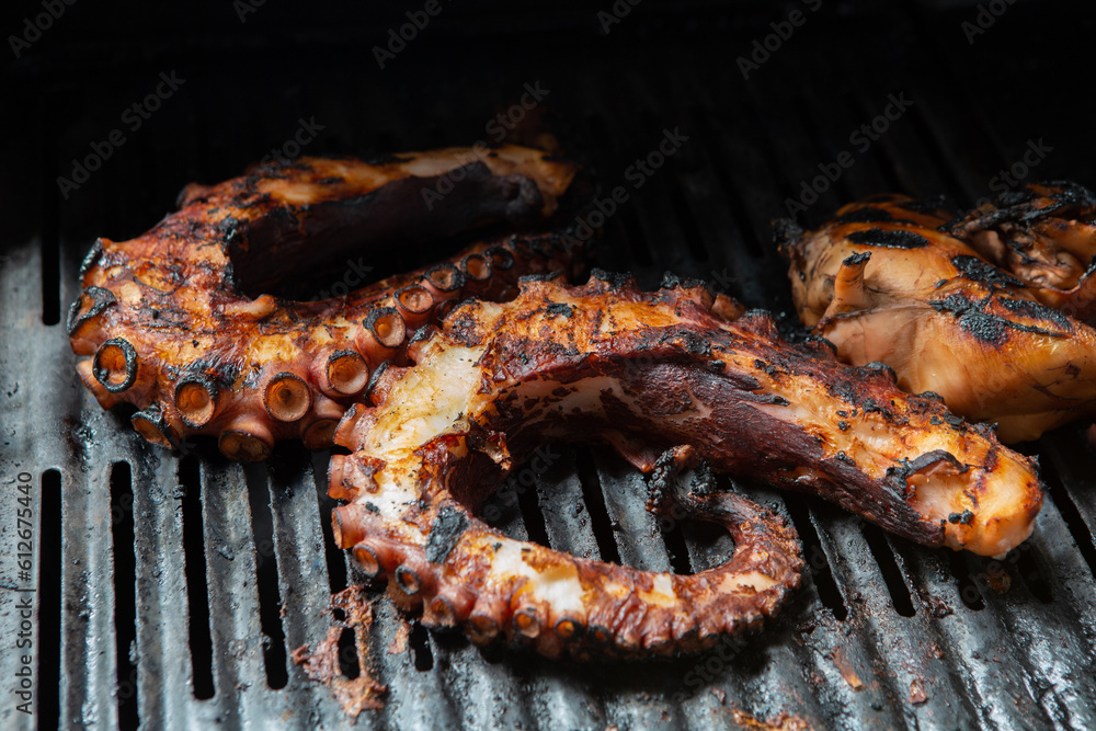 Octopus legs cooking on a barbeque Stock Photo | Adobe Stock