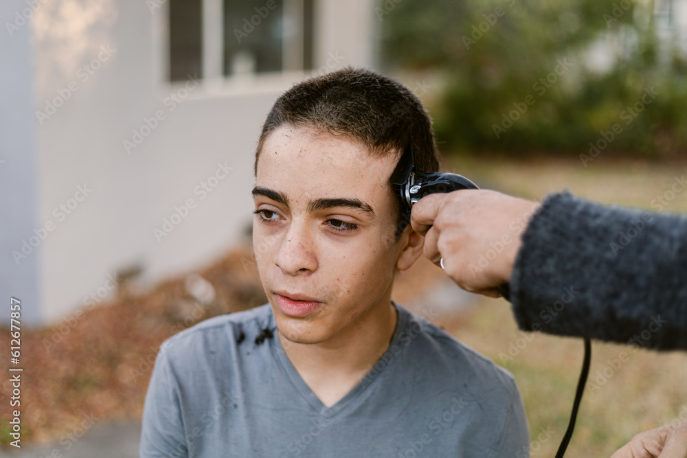 Teen boy giving a buzz cut portrait Stock Photo | Adobe Stock