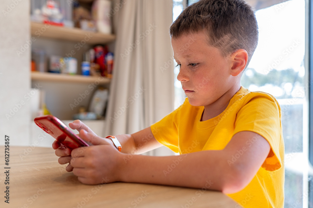 Sad child with his smartphone indoors. Danger of the Internet Stock ...