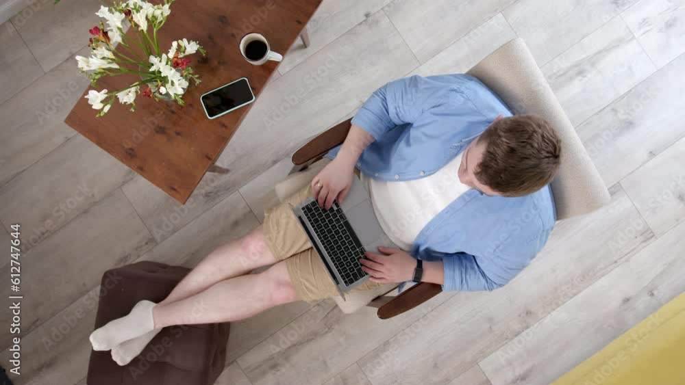 Top down view of tired burnt-out man in blue shirt at computer. guy ...