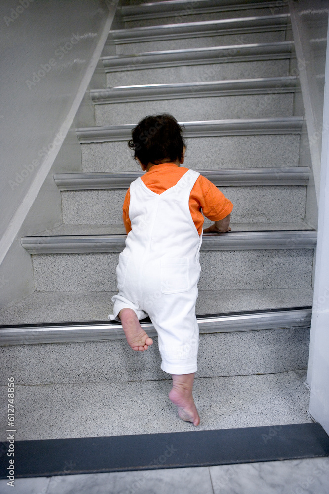 Back view of a little toddler boy climbing the stairs by himself Stock ...