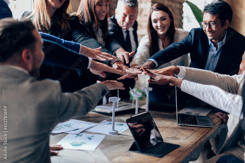 team of young engineers giving high five for the excellent team work on ...