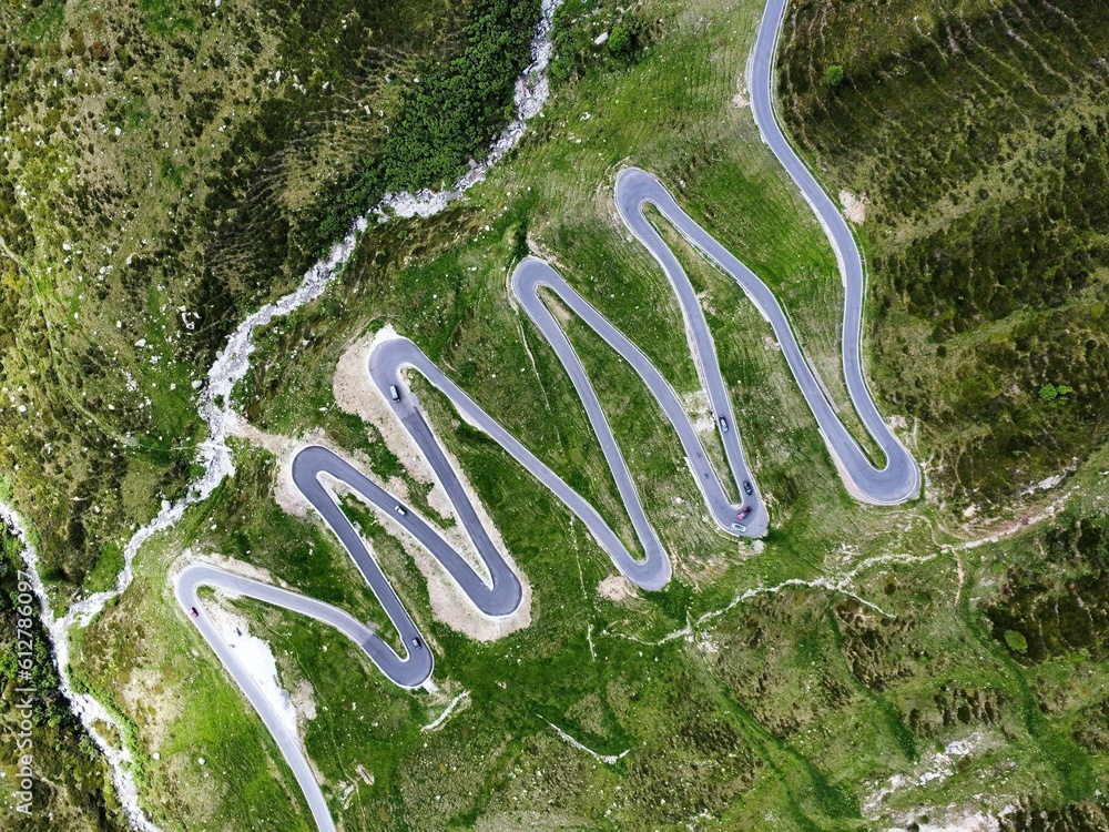 Curves of the scenic alpine Spluegen Pass in Switzerland. Aerial view ...