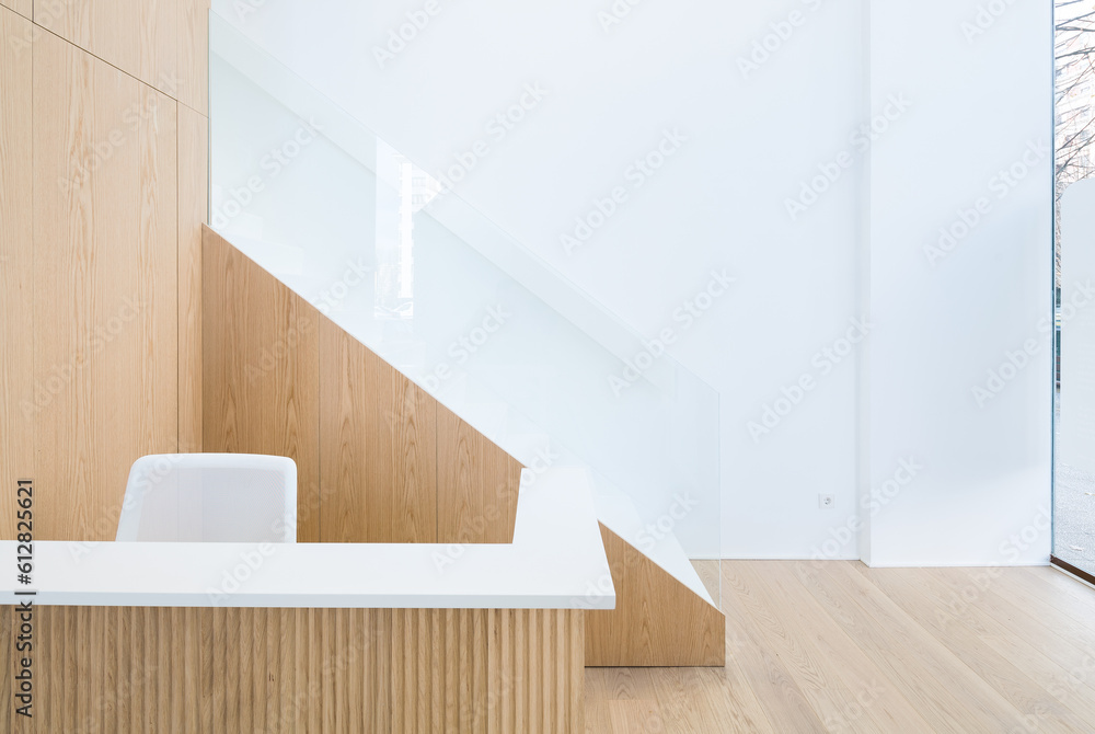 Lit reception desk and white steps in spacious building Stock ...