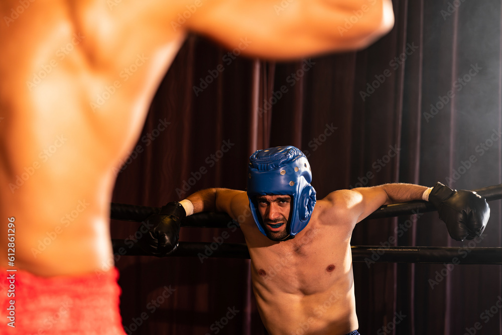 Boxer fighter with boxing helmet in fierce and intense fight while the ...