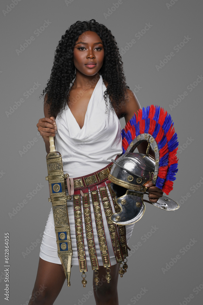 Beautiful dark-skinned model dons a white Roman tunic with a decorated ...