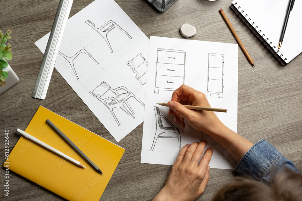Hands of an artist sketching furniture. Creation of design of chairs ...