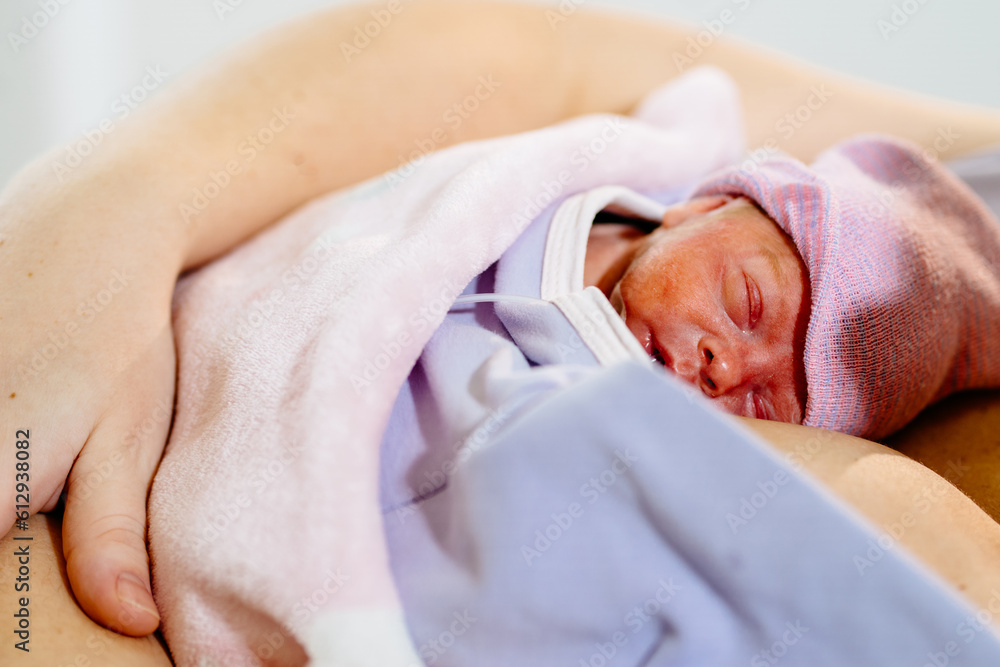 Freshly premature baby born skin to skin on unrecognizable mothers ...