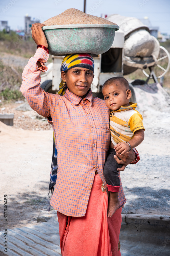 Asian Indian woman labour or coolie working at construction site ...