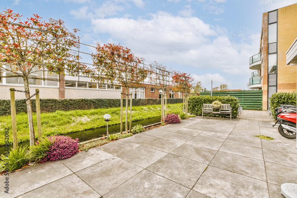an outside area with trees and flowers on the ground in front of a ...