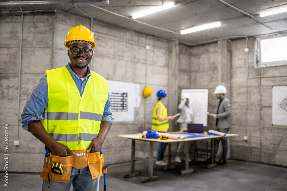 Portrait of construction worker equipped with tools and safety ...