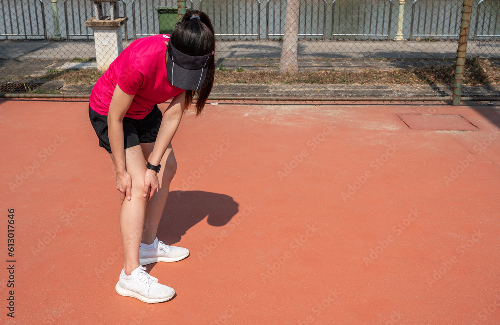 Female runner suffering from Iliotibial Band Syndrome (ITB). It cause ...