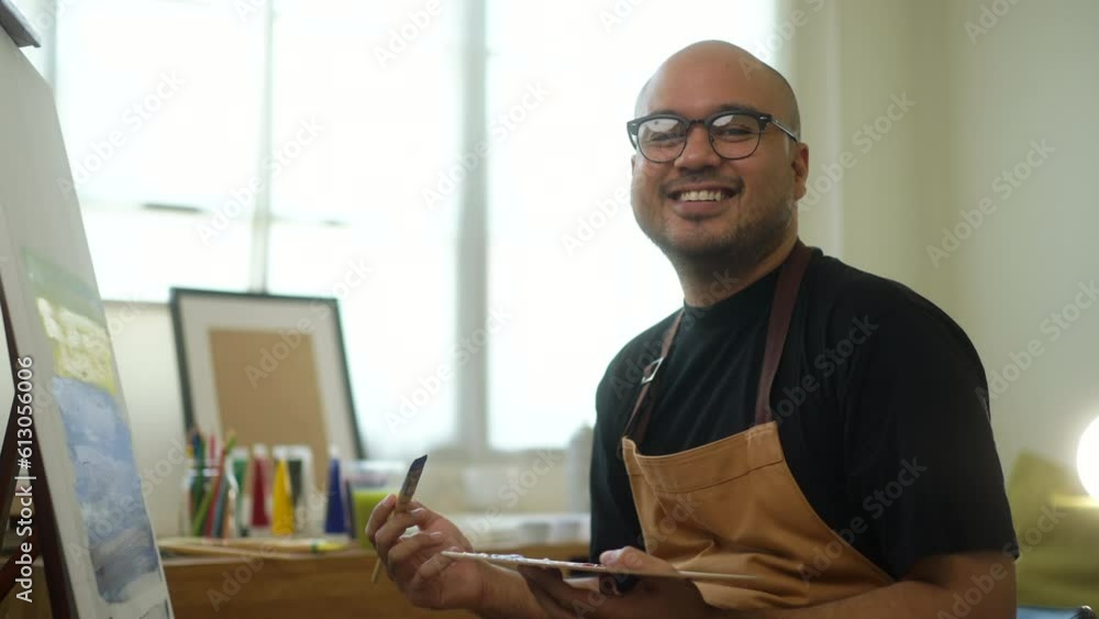 Confident man Artist painting with paint brush on canvas work art and ...