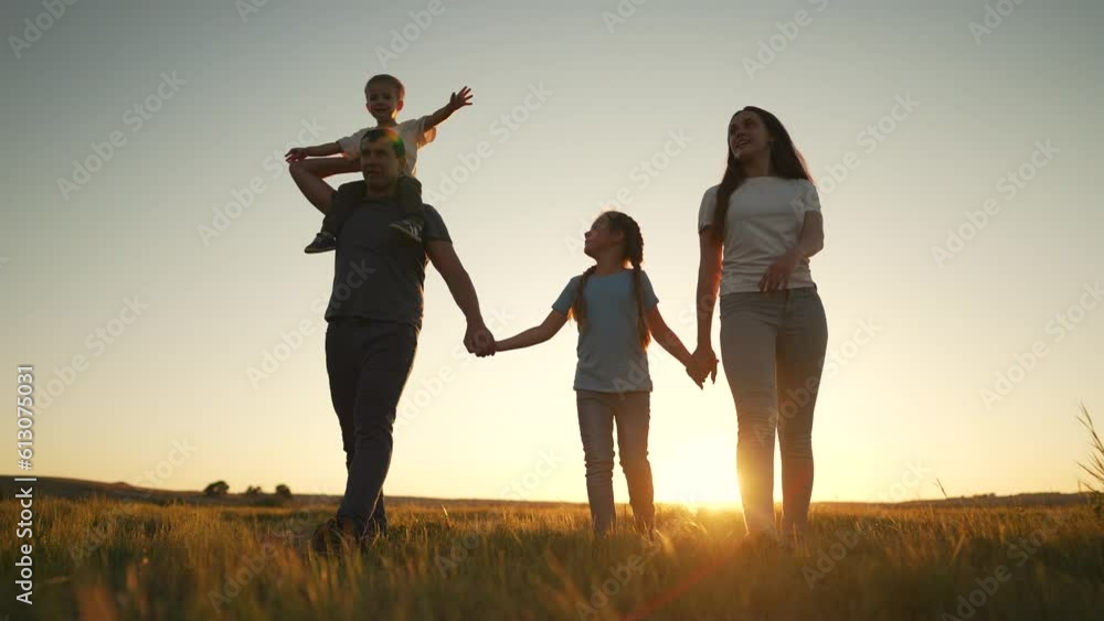 Happy family walk in field in nature.Parents and children are free and ...