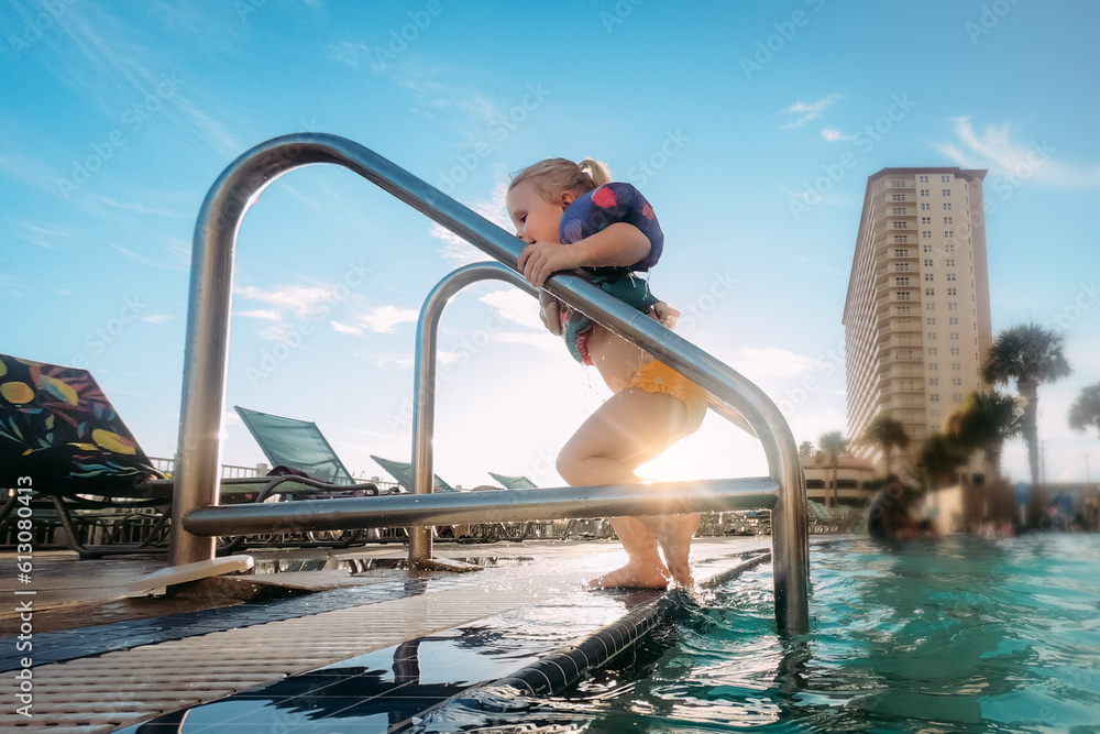 Young girl getting out of pool at tropical beach family resort Stock ...