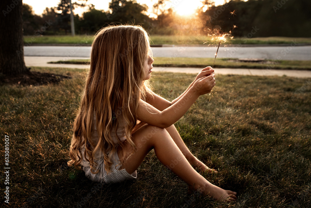 Little girl with long curly hair and sparkler Stock Photo | Adobe Stock