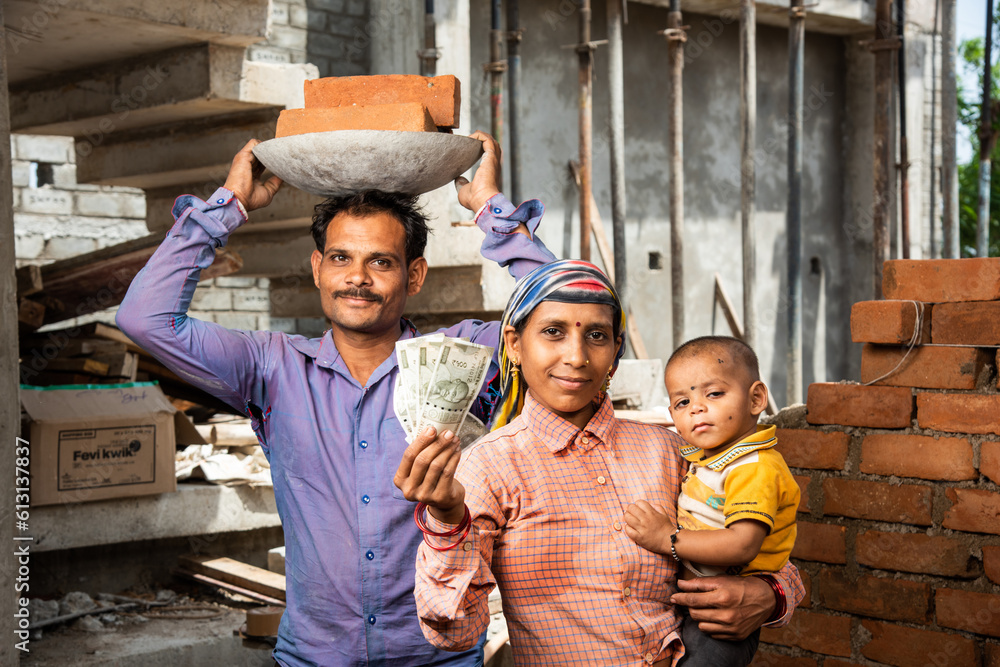 Portrait of an Indian asian labour family working at construction site ...