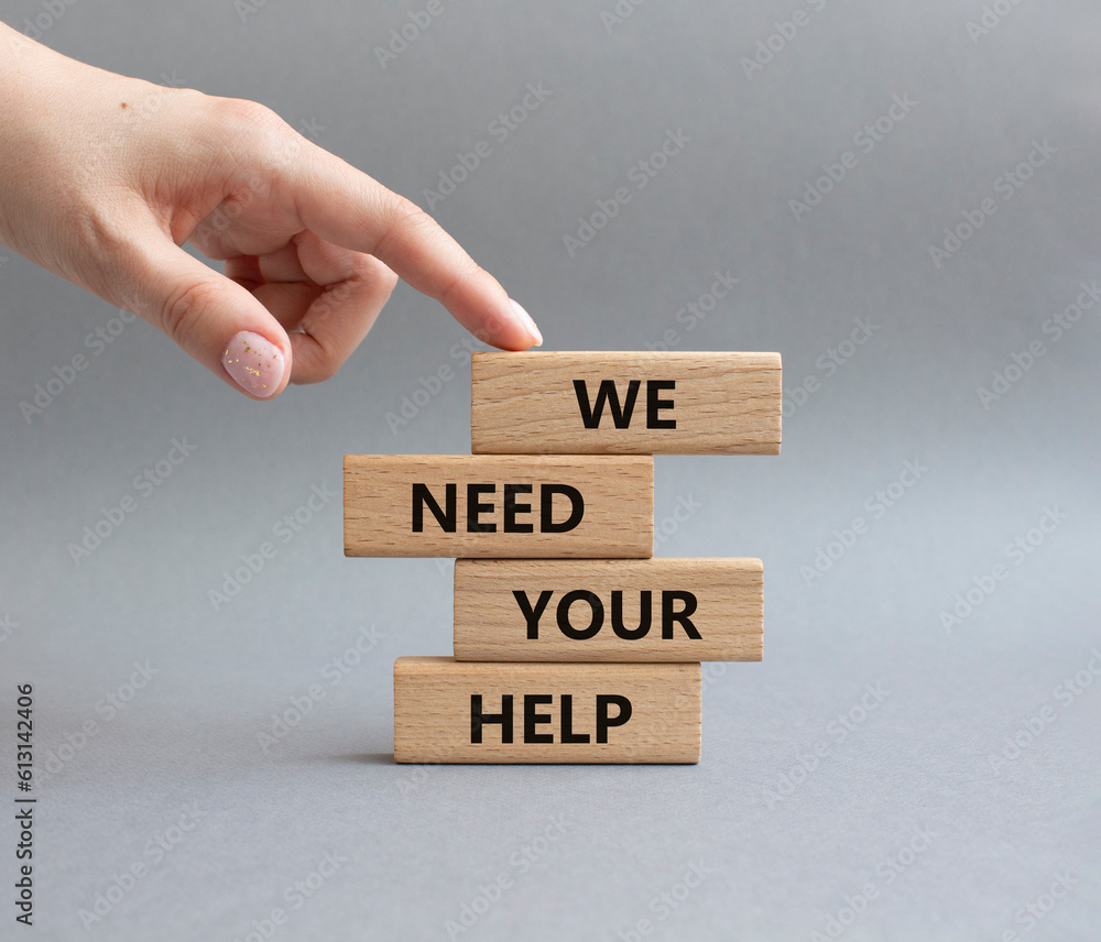 We need your help symbol. Wooden blocks with words We need your help ...