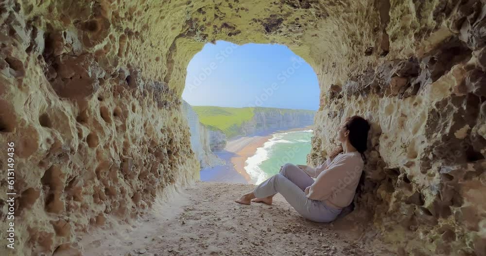 A woman on the edge of a cliff against the backdrop of the famous rocks ...