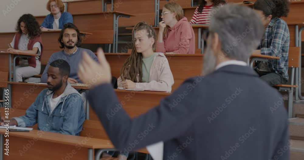 Diverse group of students enjoying lecture listening to professor ...