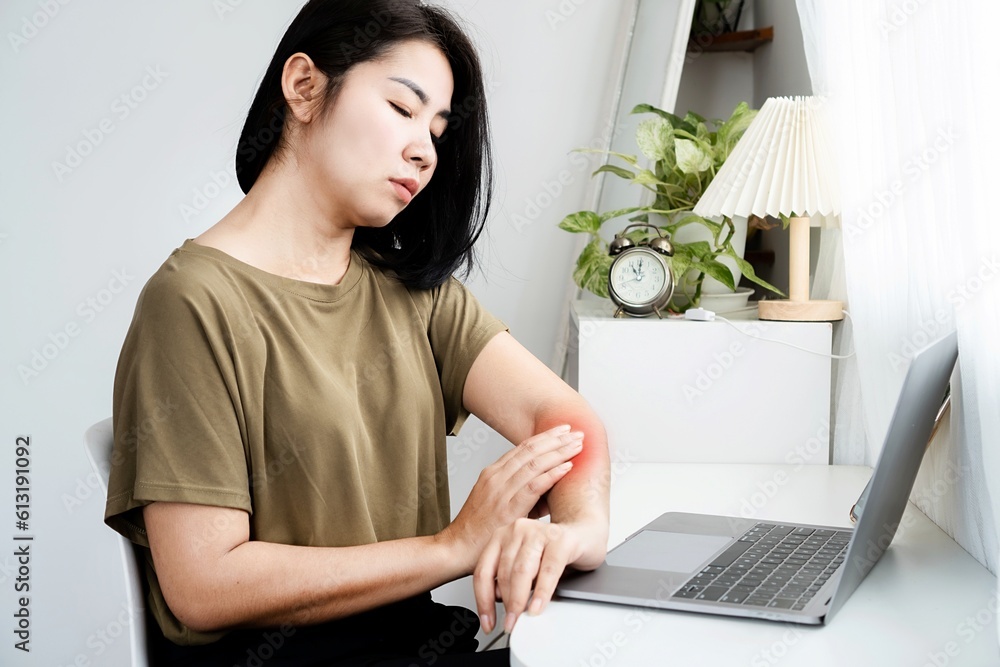 Asian Woman Suffering with Arm Pain from Laptop Usage, Overuse Injury ...