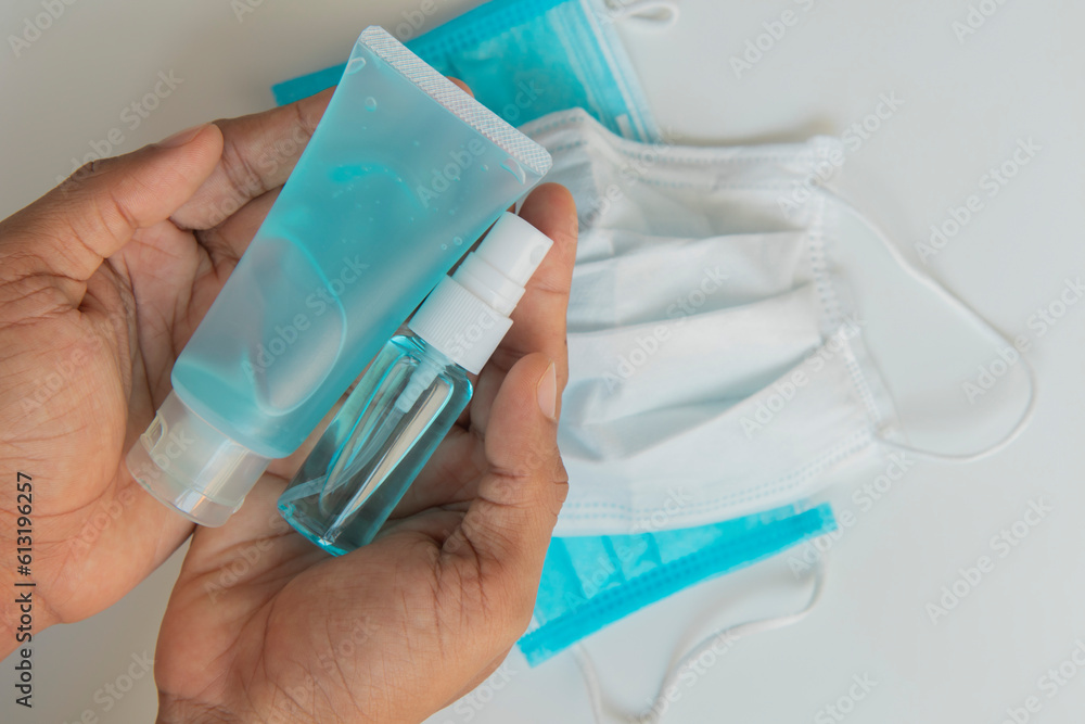 Blue hand washing gel and hand spray with mask on white background for ...