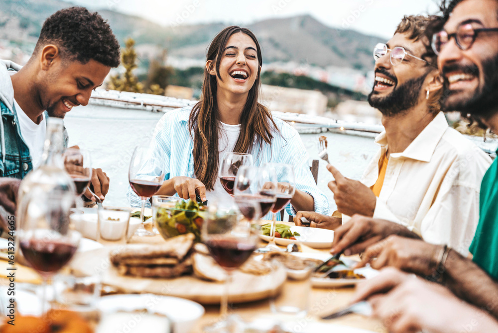 Multiethnic friends having fun at rooftop bbq dinner party - Group of ...