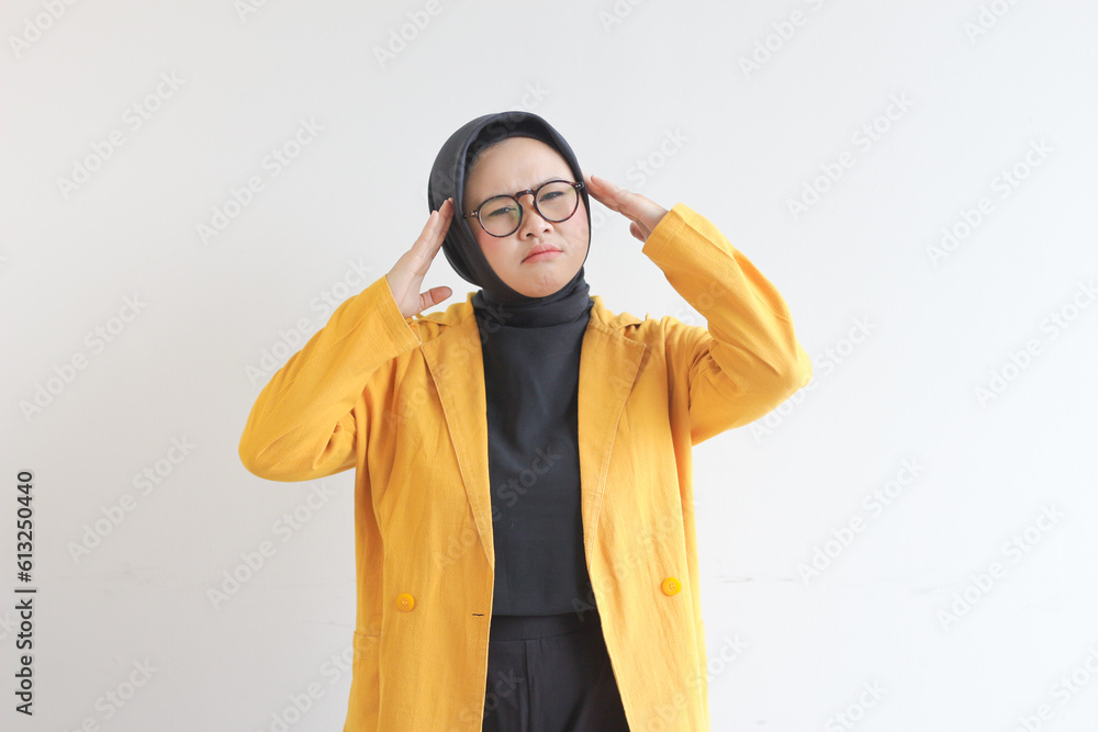 Beautiful young Asian Muslim woman, wearing glasses and yellow blazer ...
