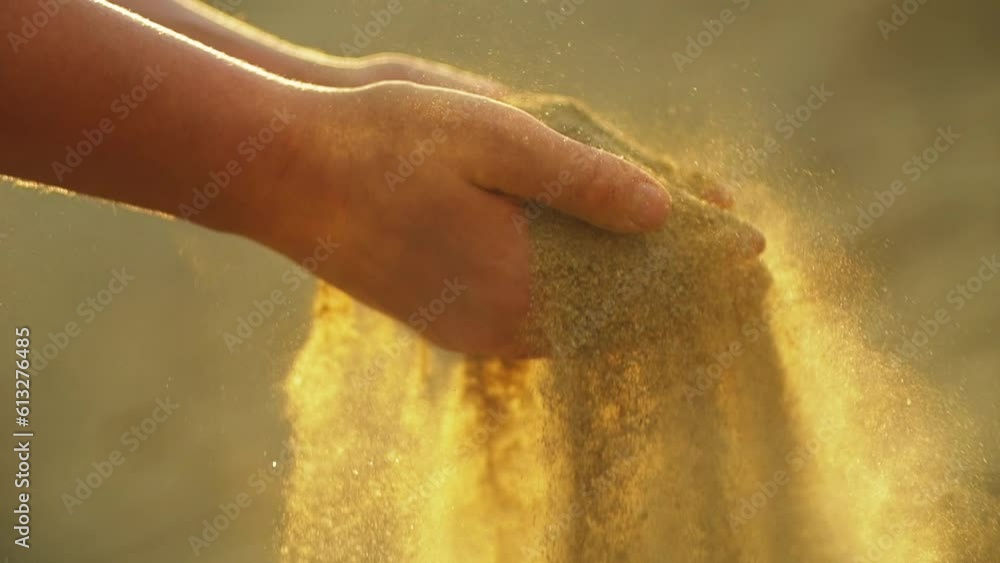 grains of sand slipping through female hands, slow motion. beautiful ...