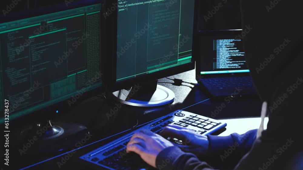 Back hooded hacker using malicious software hack corporate data center ...