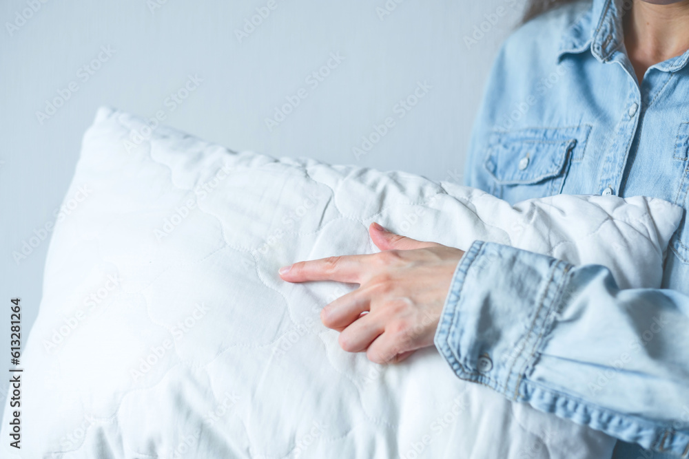 Faceless female pointing finger bed bugs on a white pillow. Health ...