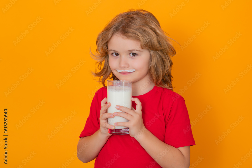 Healthy food for kids. Kid drinking milk isolated on yellow. Little boy ...