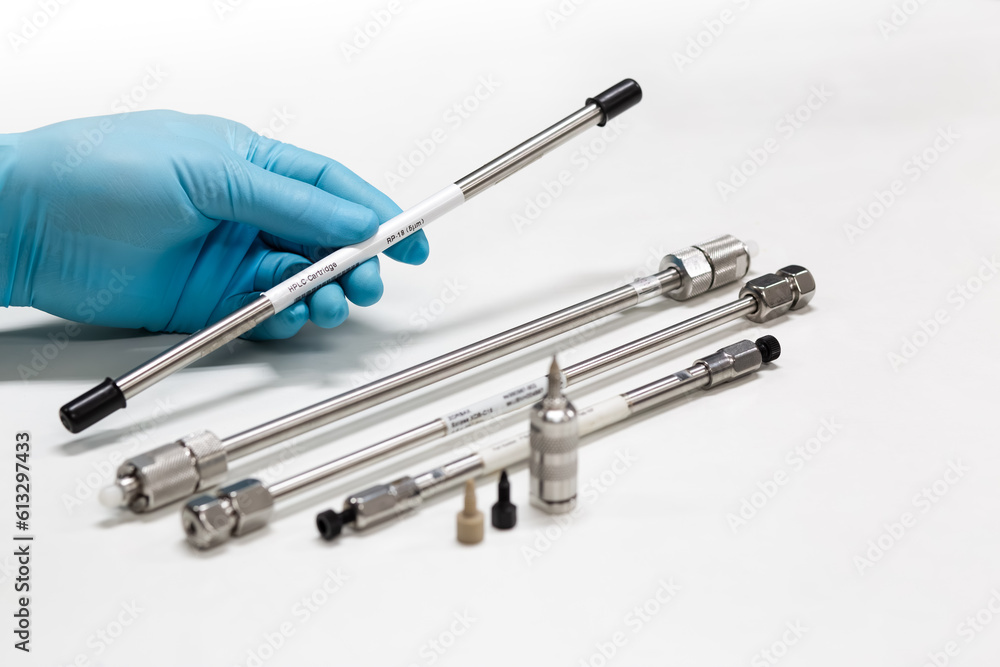 The researcher's hand shows the Cartridge column chromatography of the HPLC instrument. In ...