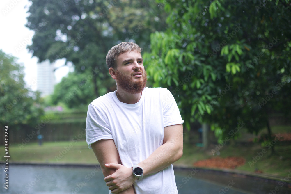 Sad frozen man under summer rain.emotional wet in the rain without ...