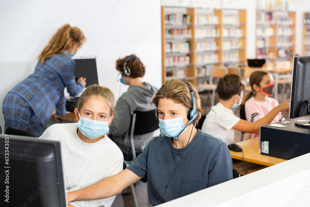 Preteen boy and girl in protective mask learn to solve problems on ...