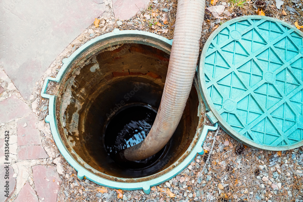 Pipe in the drainage pit. Pumping out sewage from a septic tank. Septic ...