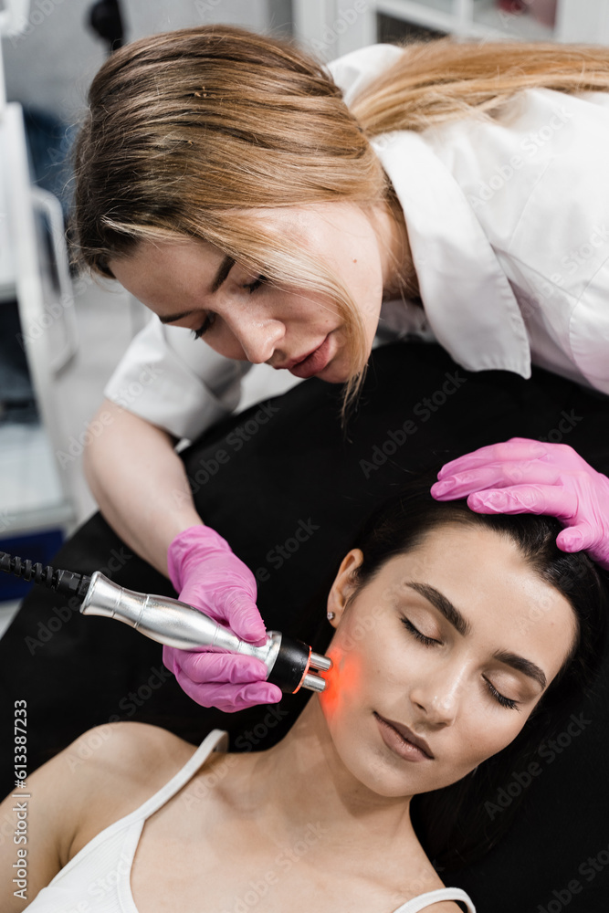 Radio frequency lifting with red light for young woman close-up ...